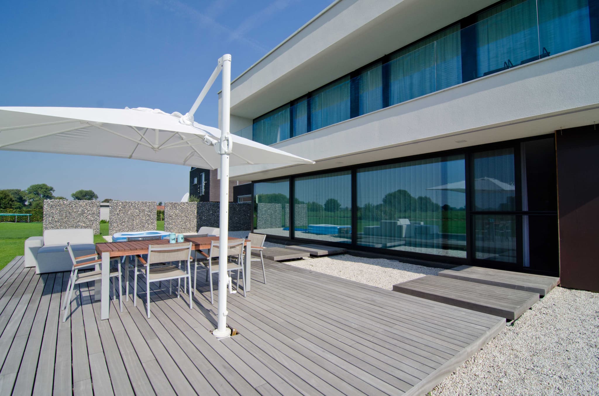 Grey padouk terrace in the garden of an elegant and modern architect's ...